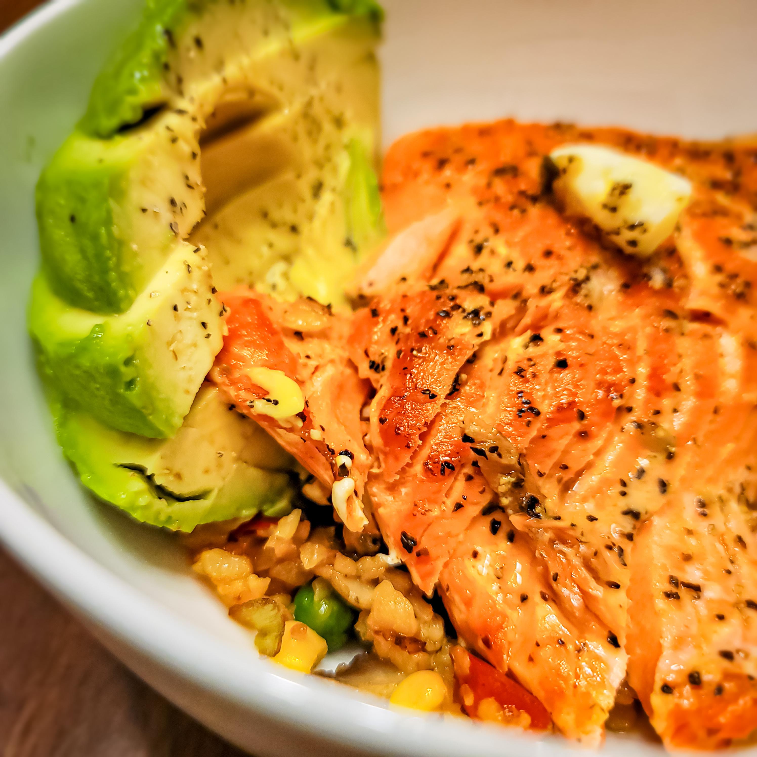 Lemon Pepper Sockeye Salmon w/ avocado, on a bed of Cauliflower fried "rice", cooked in Coconut ...