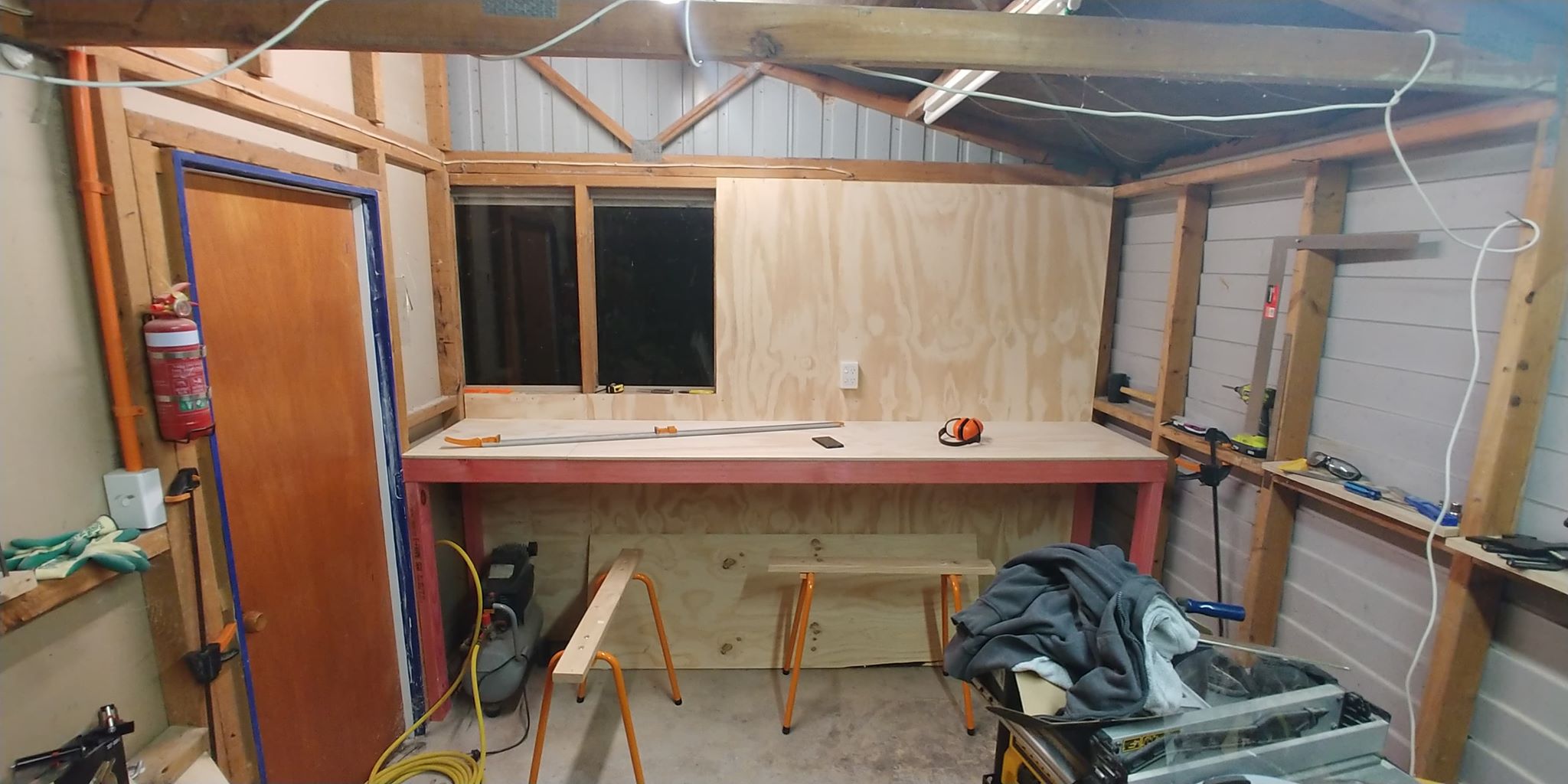Lined the back wall of my garage and finally built a starter workbench. | Scrolller