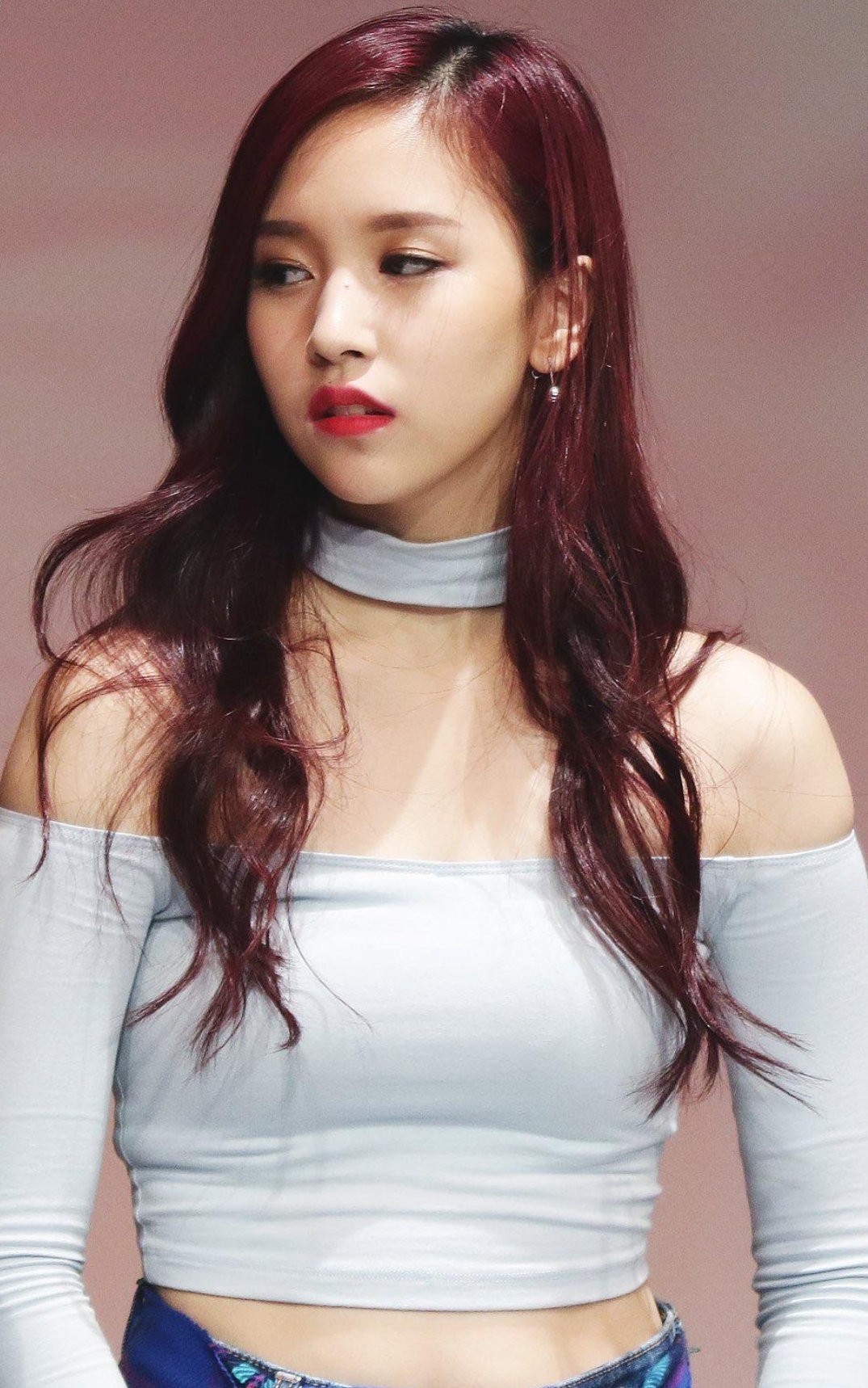 Mina - red hair, light blue top, jean shorts, close up | Scrolller