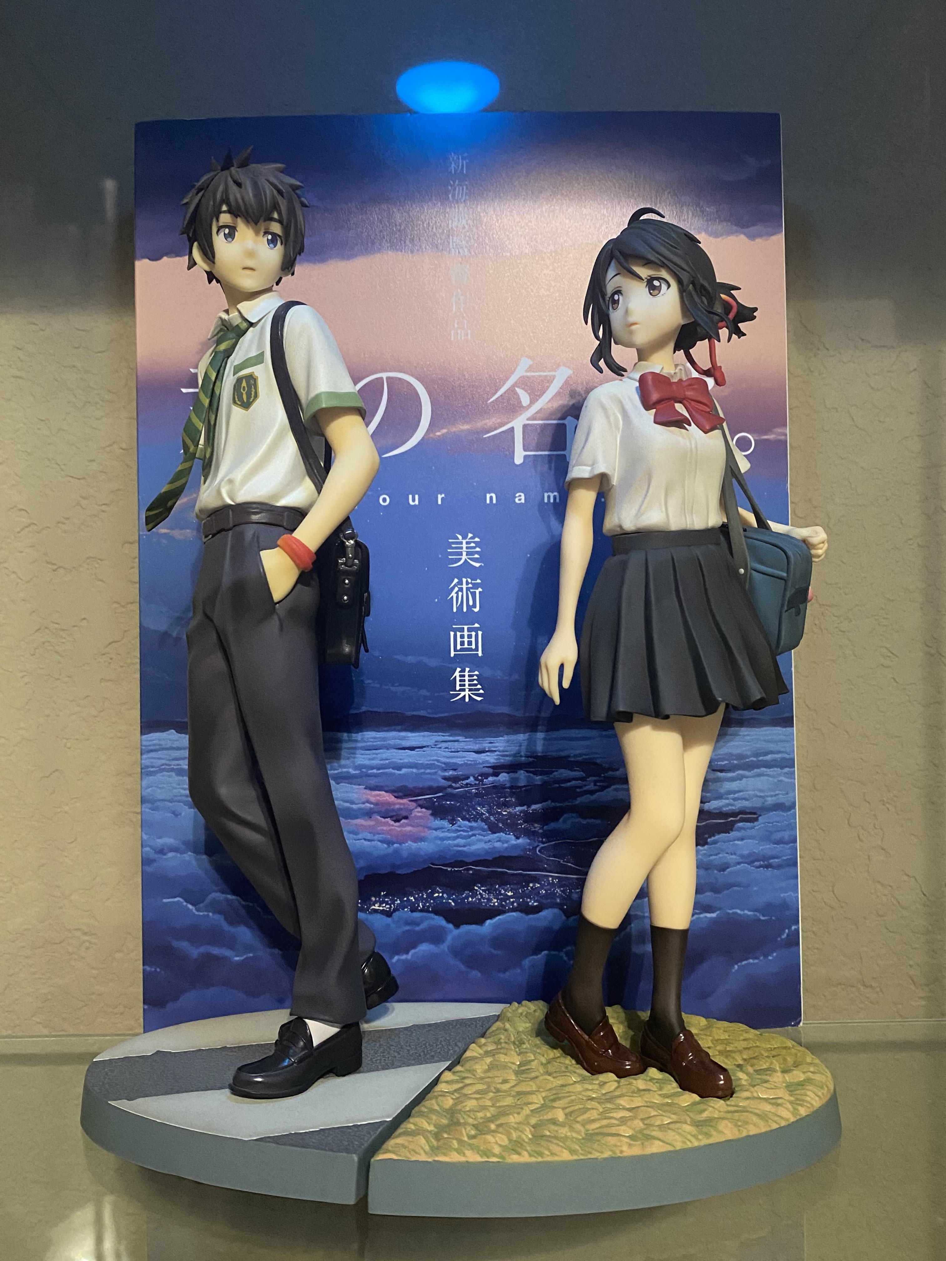 Mitsuha and Taki figurines with the Kimi No Na Wa art book | Scrolller