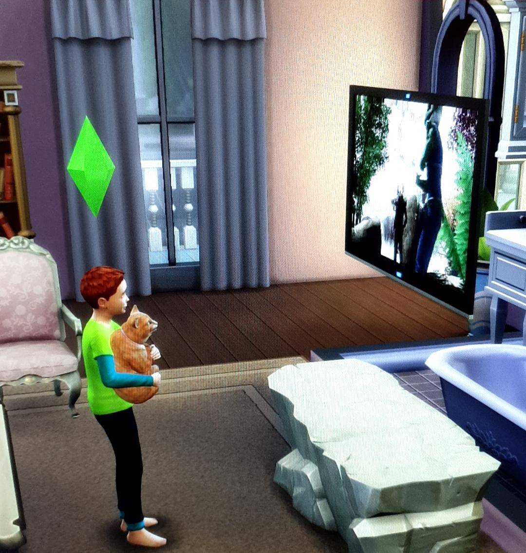 My little sim is hugging a kitty and watching tv together. So cute! | Scrolller