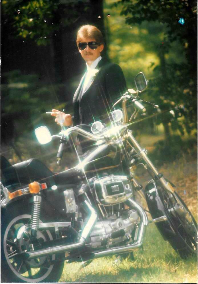 My uncle next his Harley (Sportster? Low rider?) sometime in the 1980’s | Scrolller
