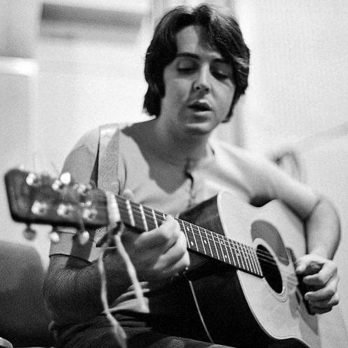 Paul playing guitar | Scrolller