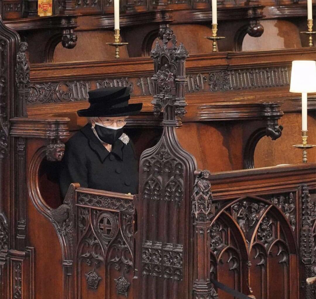 Queen Elizabeth II sitting alone in St. George’s Chapel for the service of Prince Philip ...