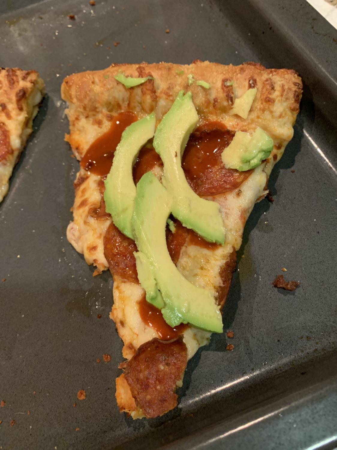 Reheated pepperoni pizza with Valentina and avocado slices | Scrolller