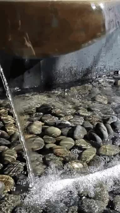 Rock passing through fountain | Scrolller