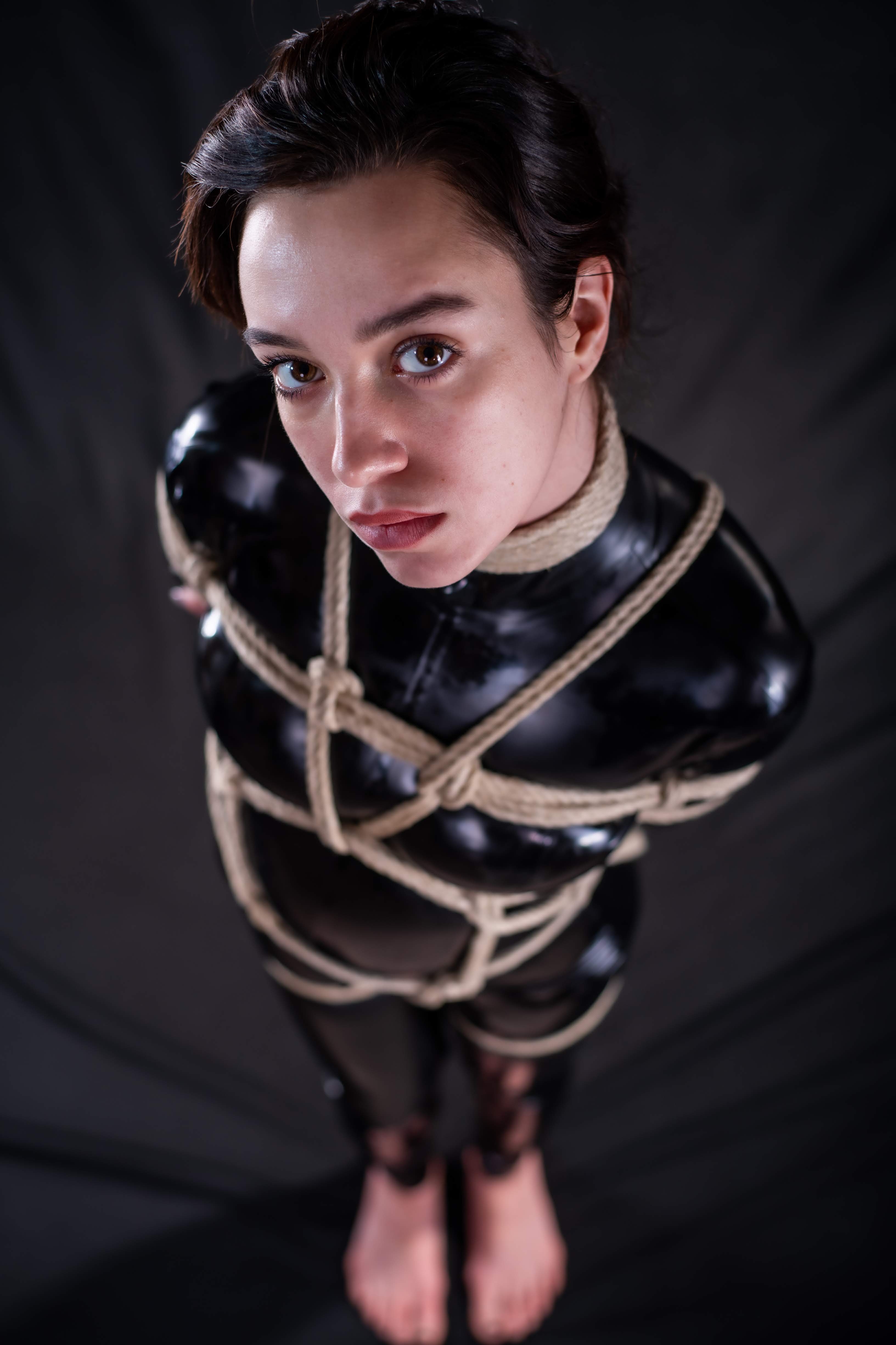 Rope over latex catsuit. | Scrolller