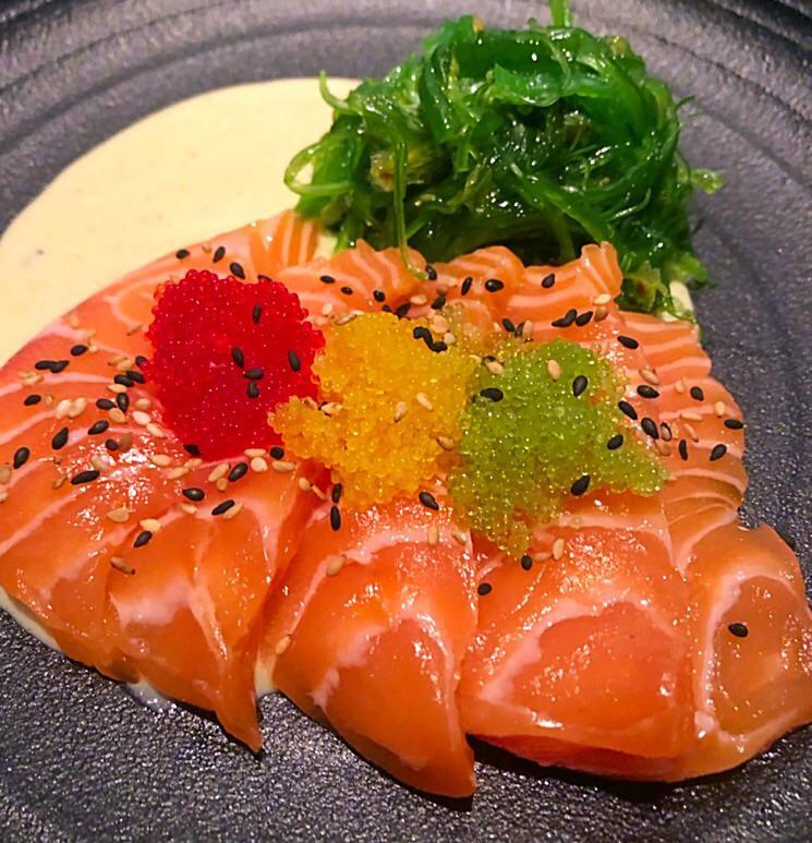 Salmon sashimi, wakame ,toasted sesame seeds garnished with tobiko and a shallot miso sauce ...