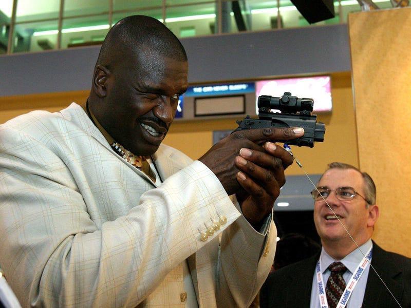 Shaq holding a gun | Scrolller