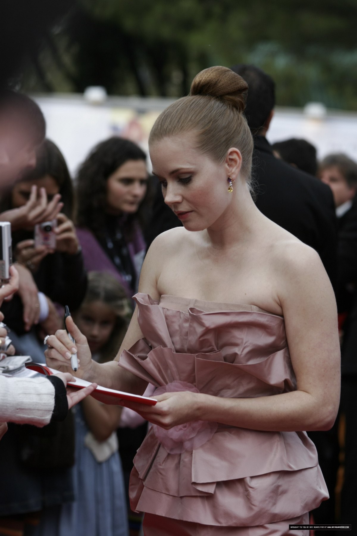 Signing autographs | Scrolller