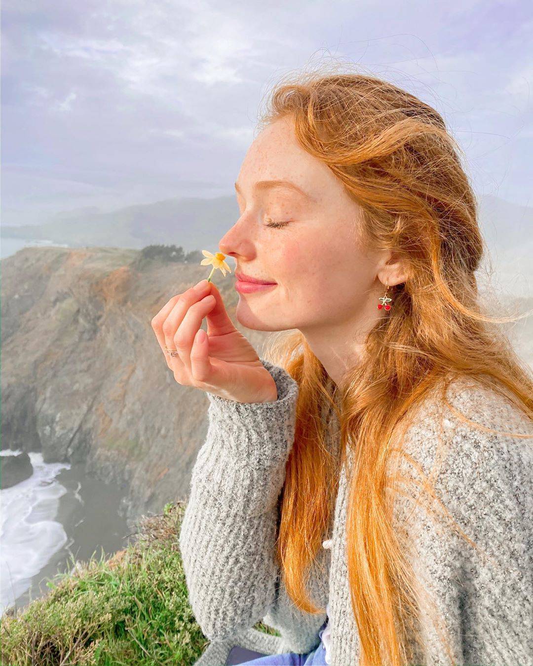 Smelling a flower | Scrolller