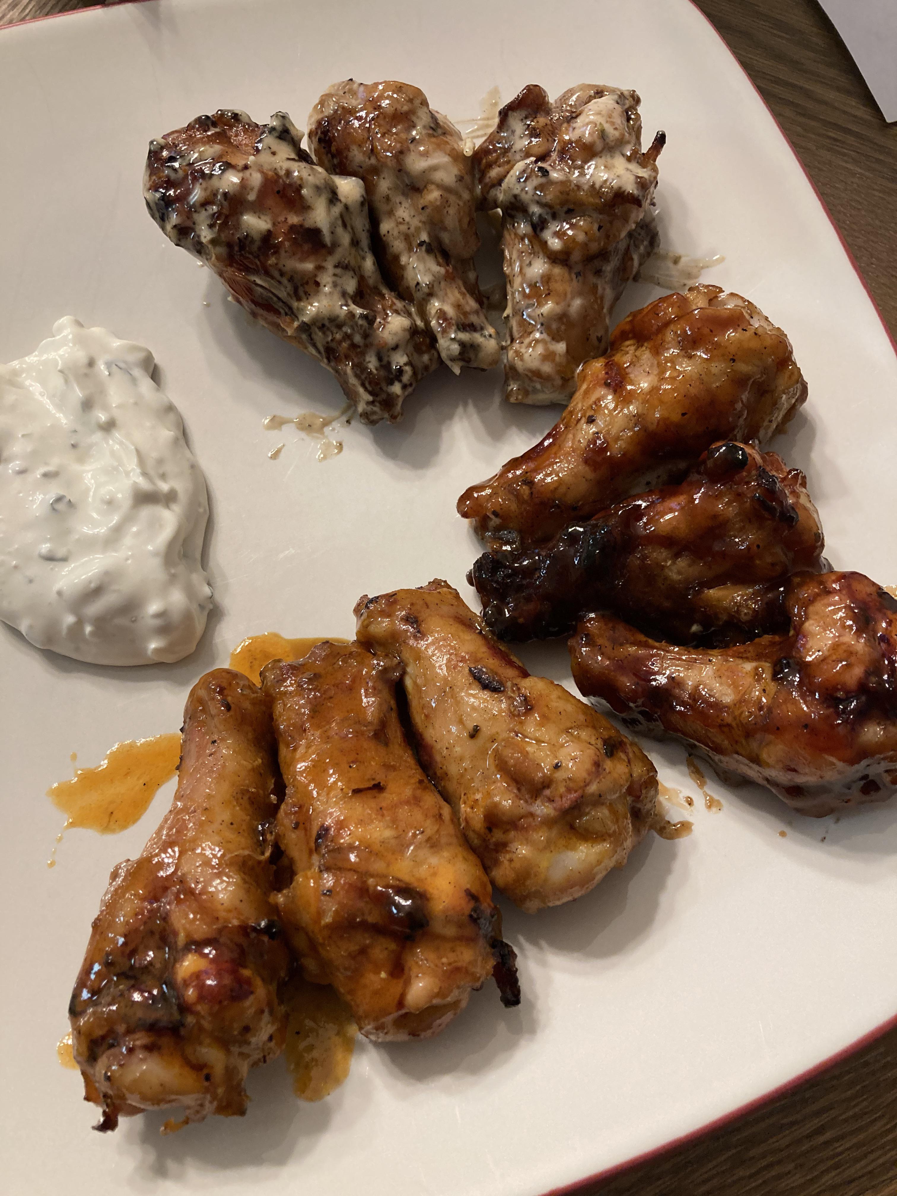 Smoked wings tossed in Parmesan garlic, bbq, and buffalo with homemade bleu cheese. | Scrolller