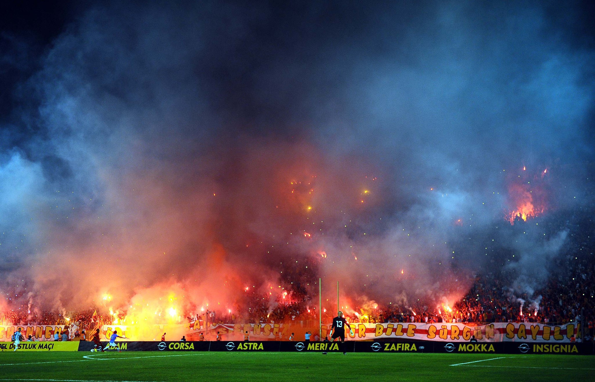 Soccer fans start up a fire during a game. Galatasaray vs. Malaga ...