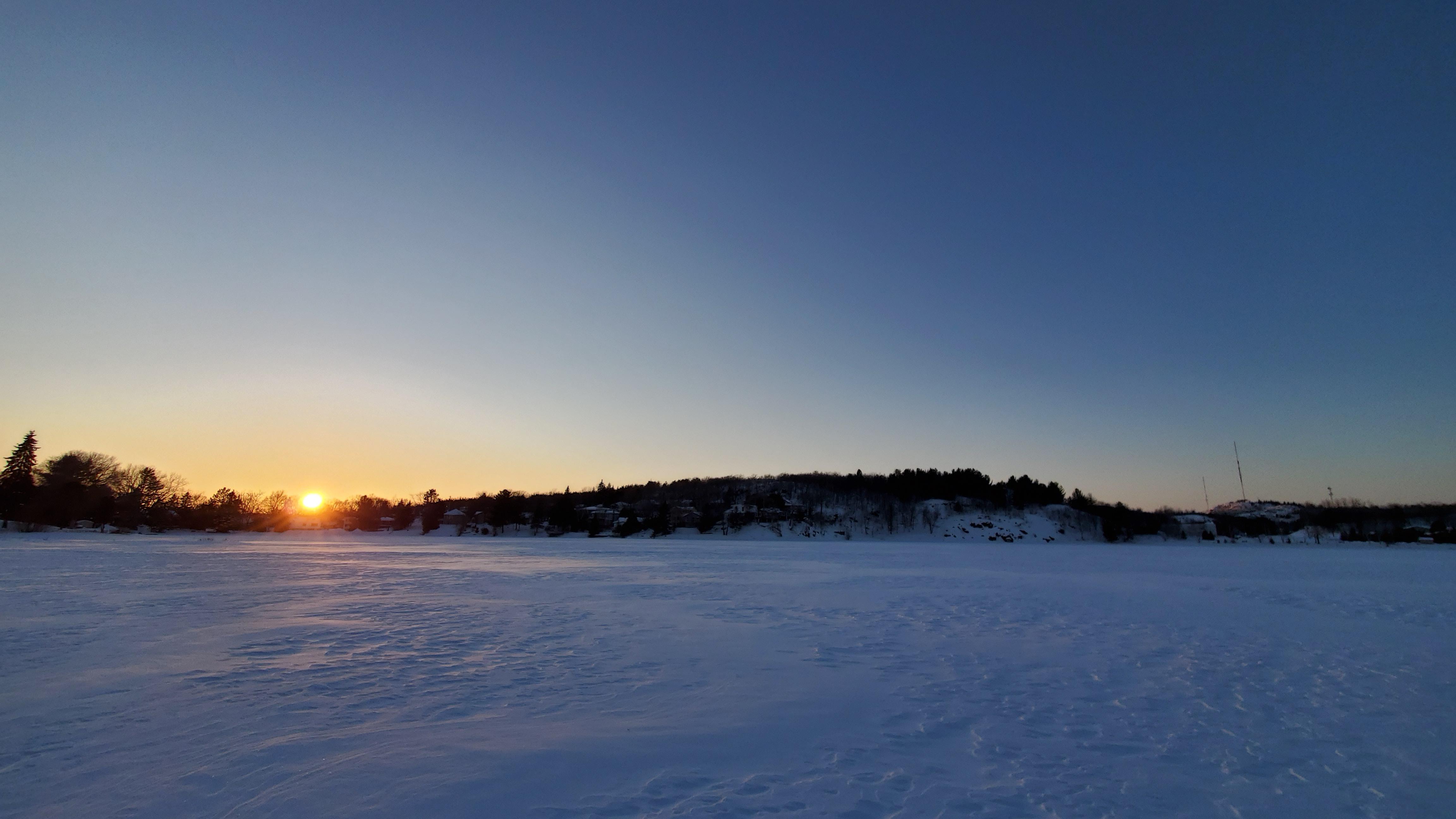 Sun setting on hard water in Northern Ontario. | Scrolller