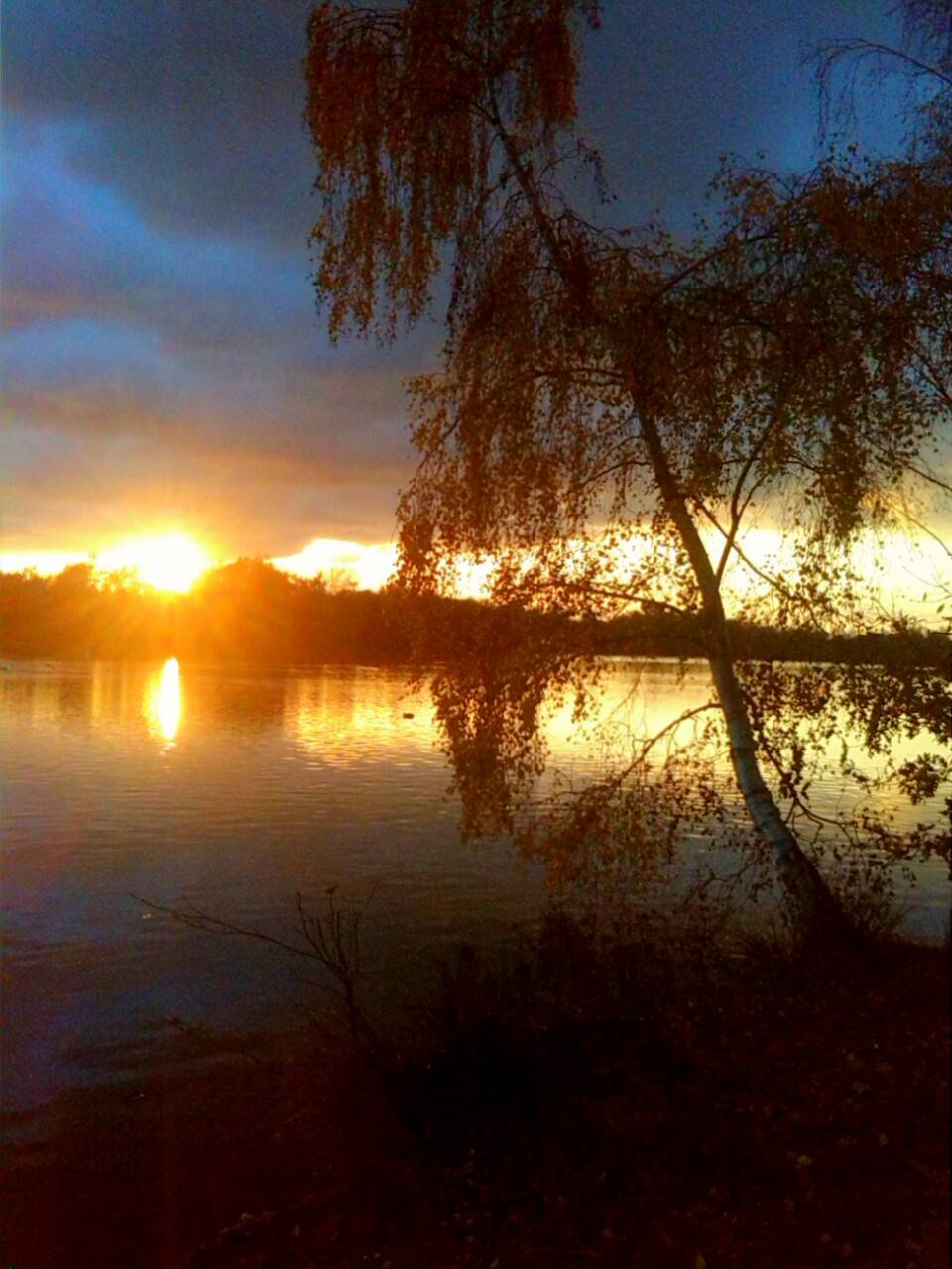 Sun setting over a lake | Scrolller