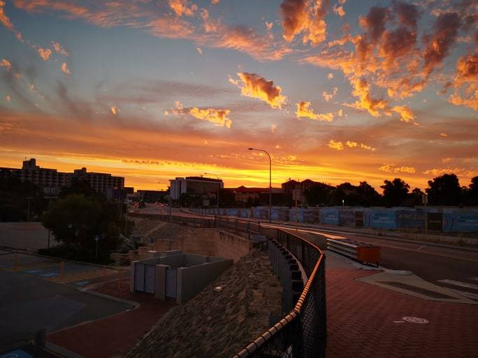 The sun setting behind my workplace. | Scrolller