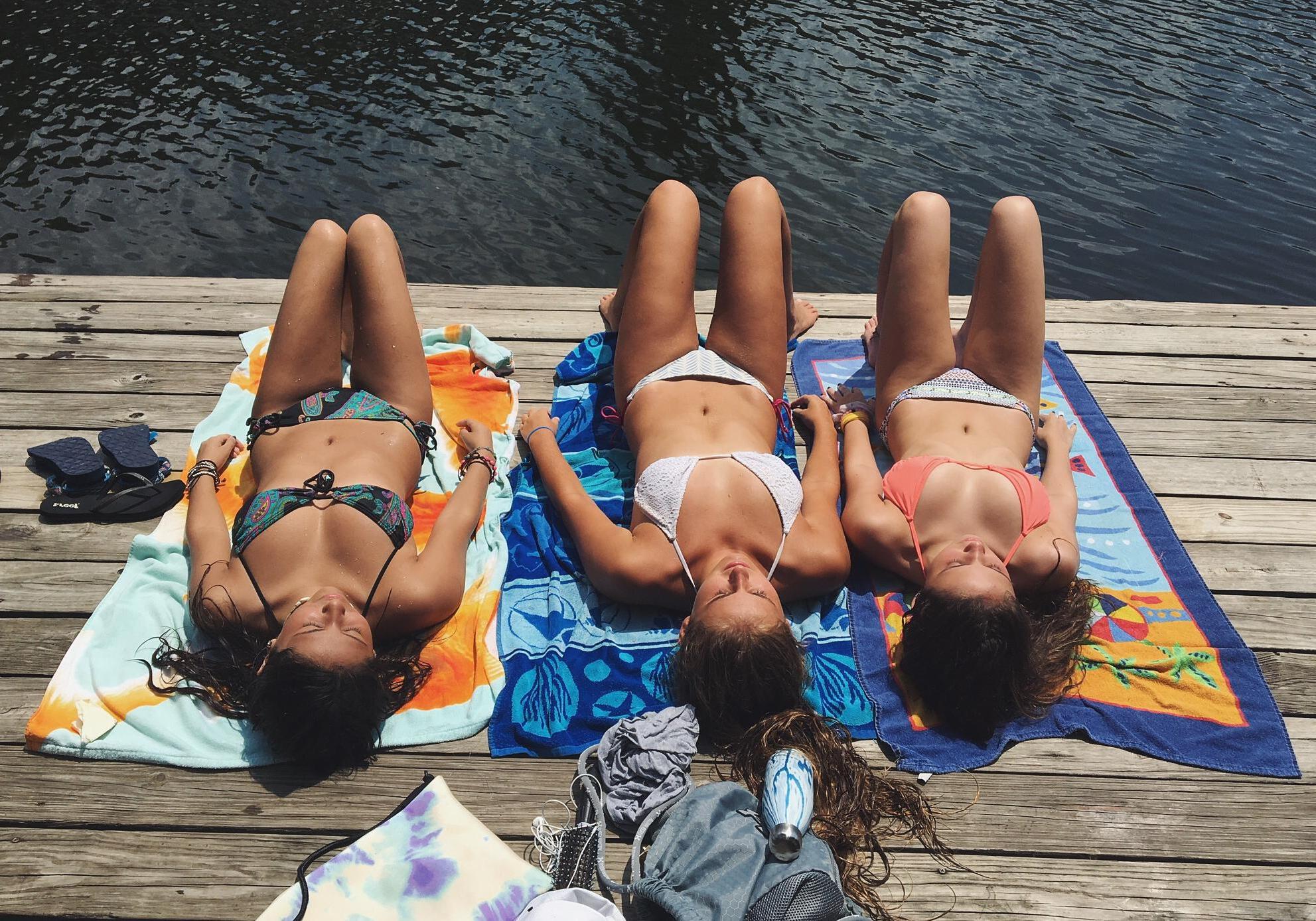 Three friends on the dock | Scrolller