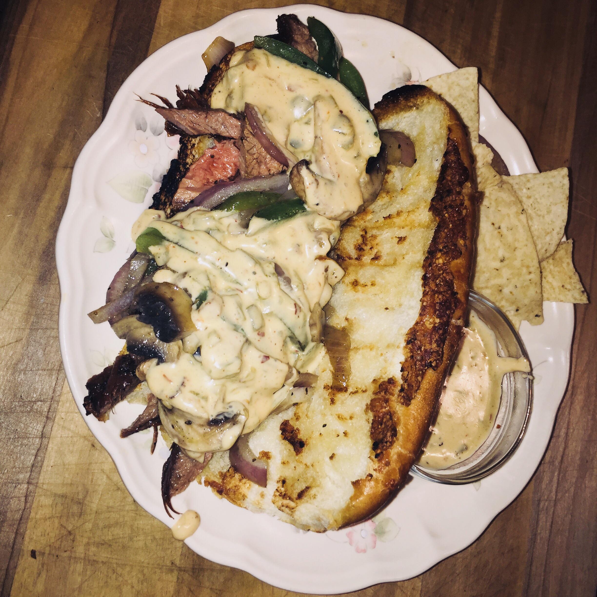 Tri-tip Philly Cheesesteak with homemade Queso, bell pepper, onion, and mushroom | Scrolller