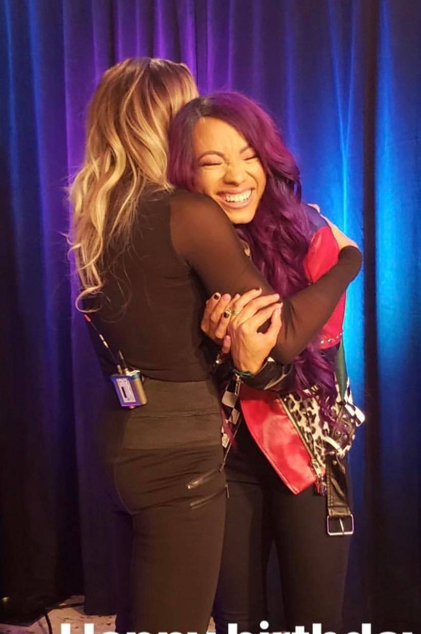 Trish hugging Sasha | Scrolller