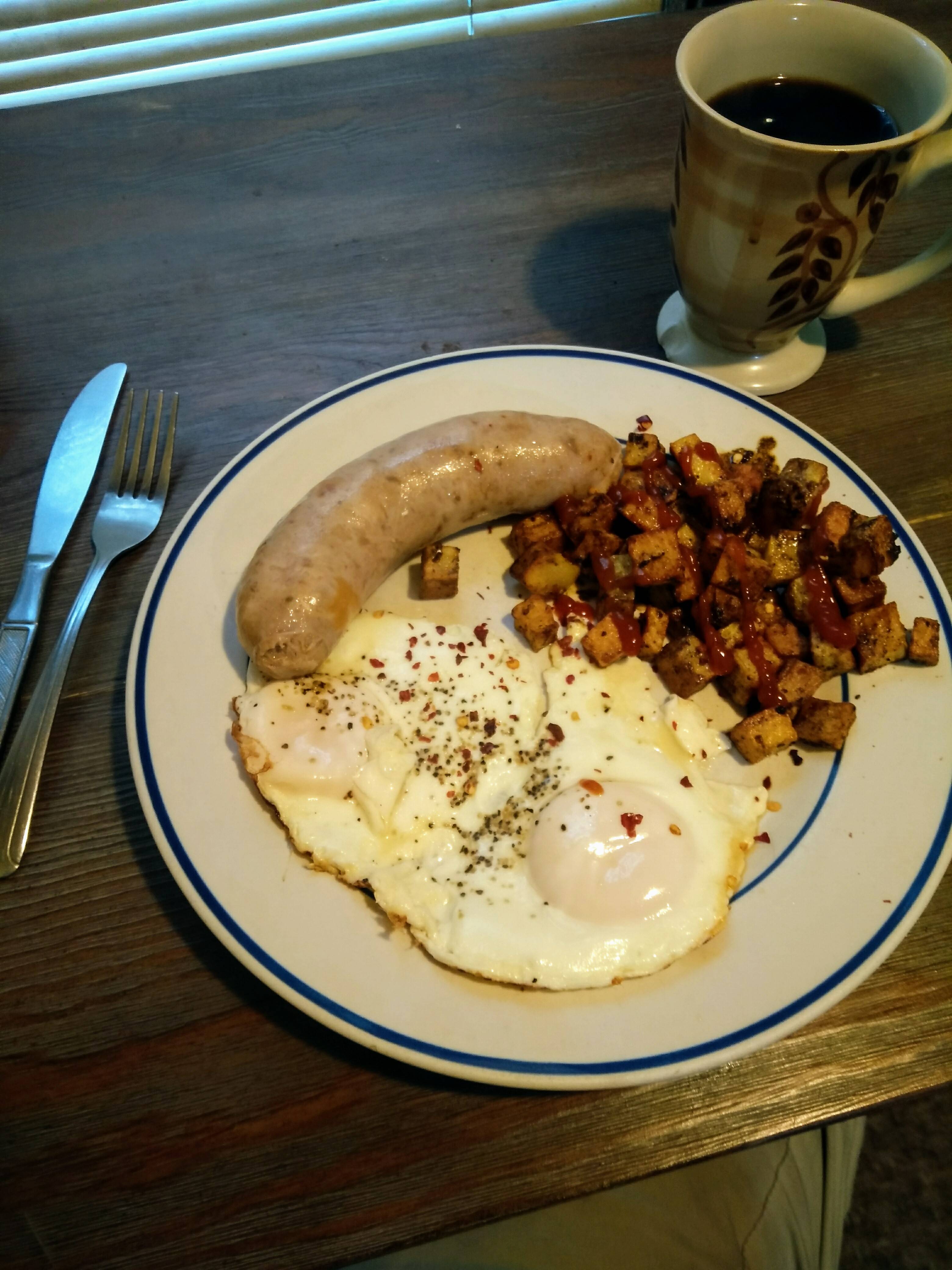Two basted eggs, crispy chili dusted home fries, and a massive banger. | Scrolller