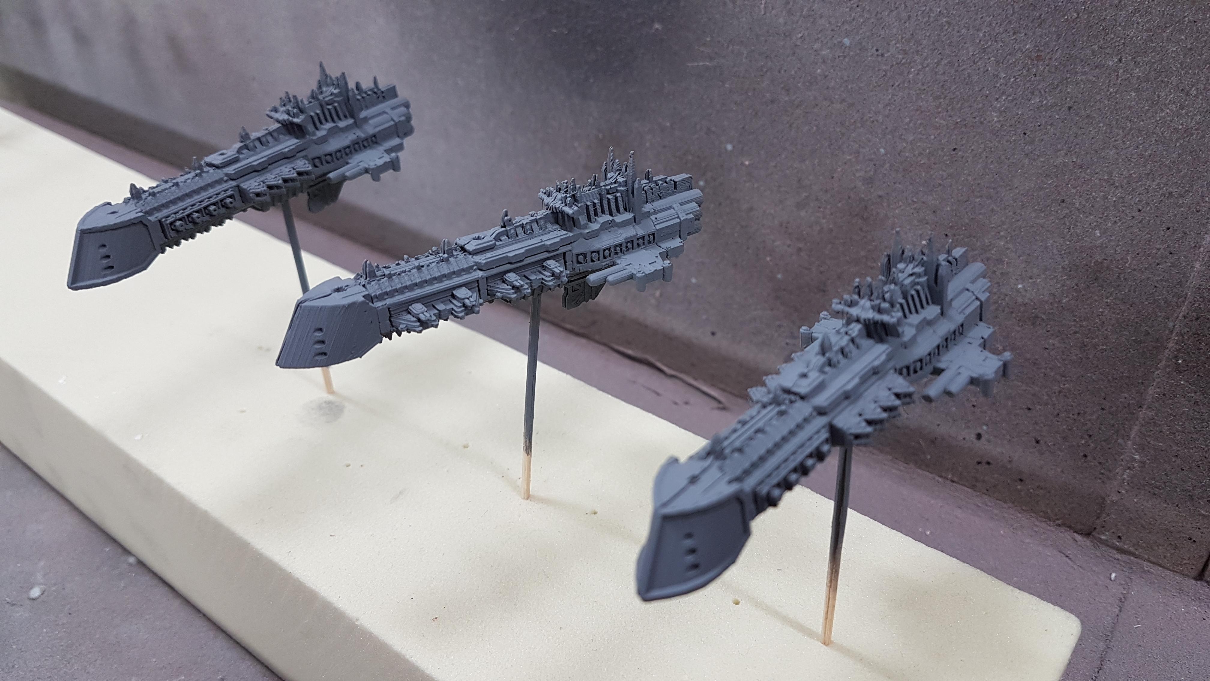Two Gothic and a Dictator Class Cruiser recieving a coating of primer | Scrolller