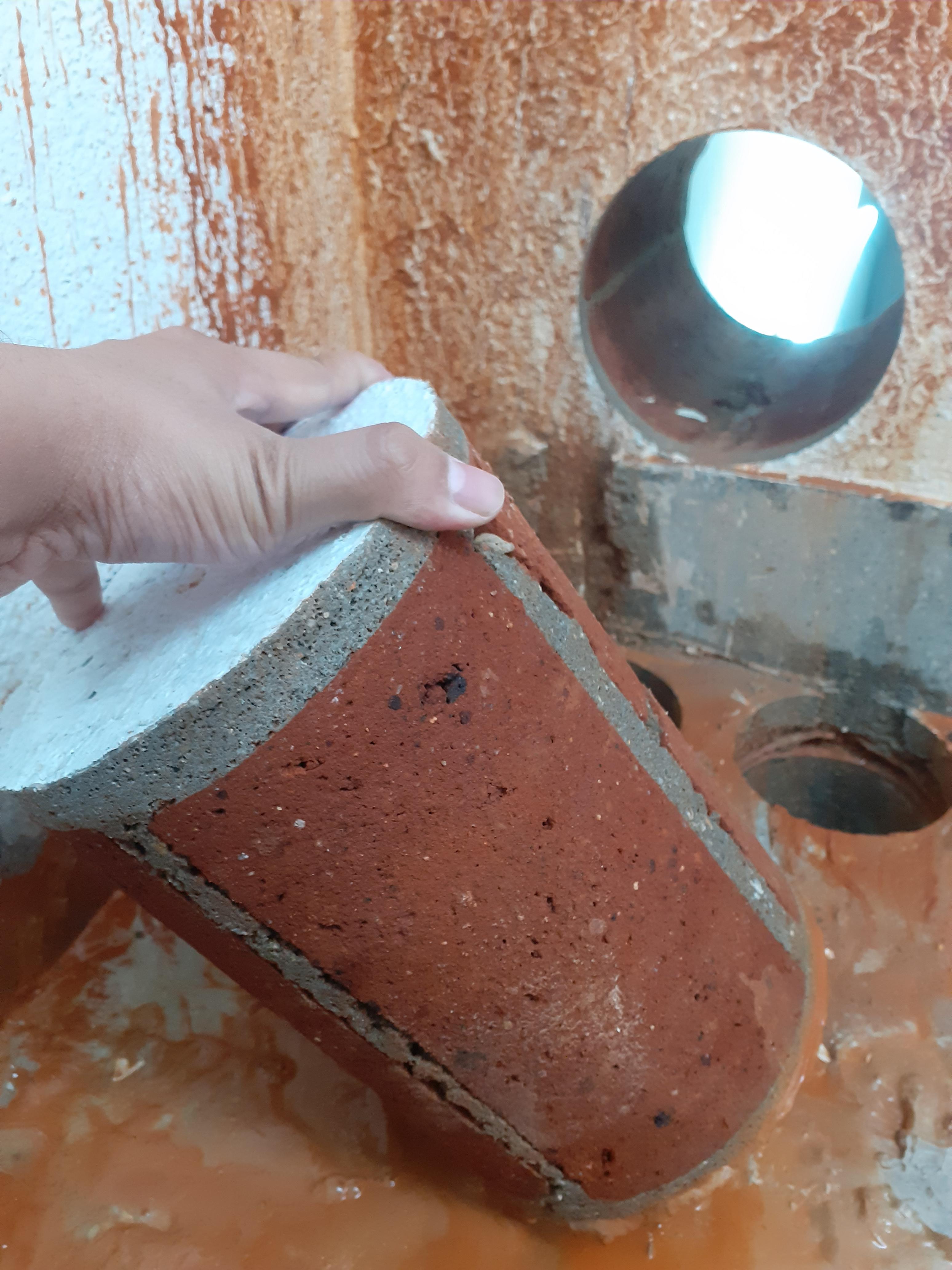 A smooth hole in the wall and it's circular brick/cement layers. | Scrolller