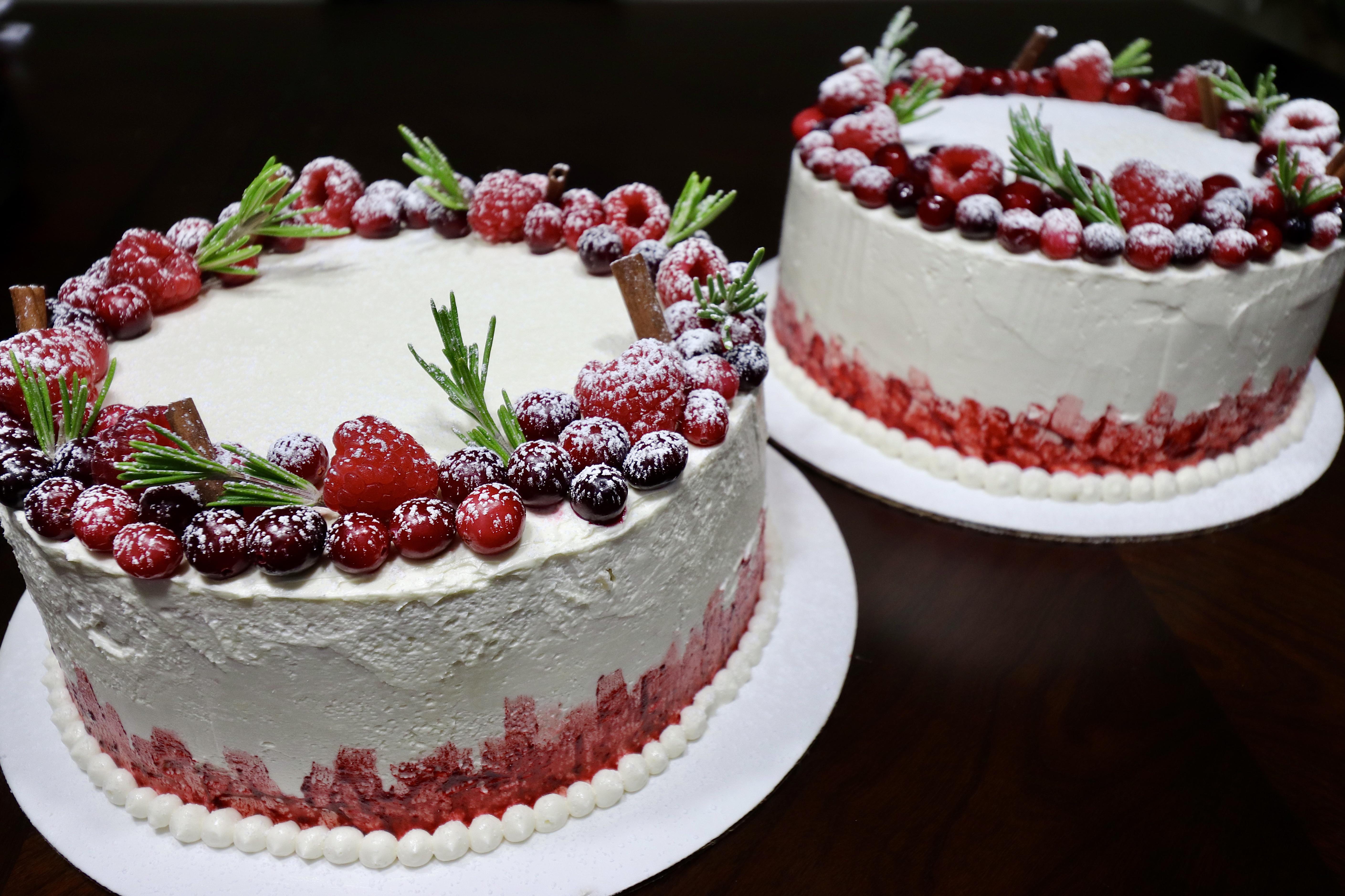 Almond biscuit layer cake with a raspberry/cranberry filling and frosted with buttercream ...