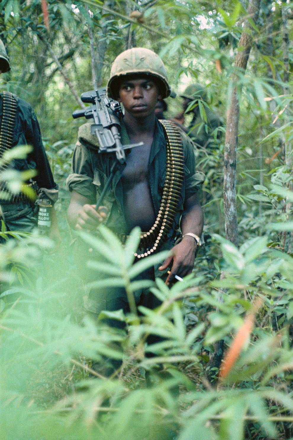 An annoyed looking U.S. Army M60 Machine Gunner down in the boonies; South Vietnam, c. 1968-1969 ...