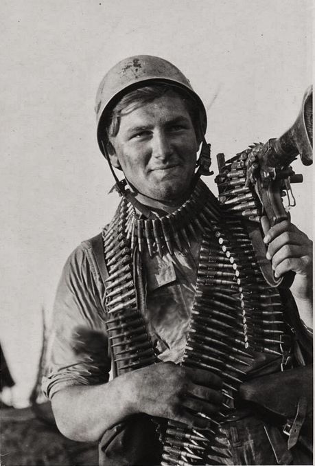Close up photo of a heavily armed Fallschirmjaeger with his MG34 - Date unknown | Scrolller