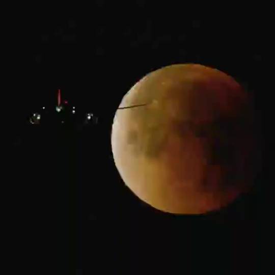 Delta Flight captured in video flying past a Lunar Eclipse | Scrolller