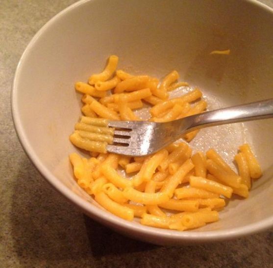 Eating Mac n' Cheese by arranging a single noodle on each fork tine. | Scrolller