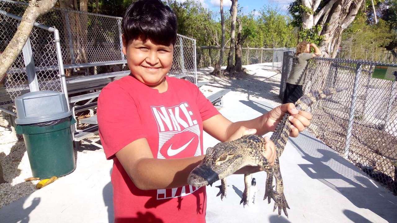 Fat Indian kid holding croc | Scrolller