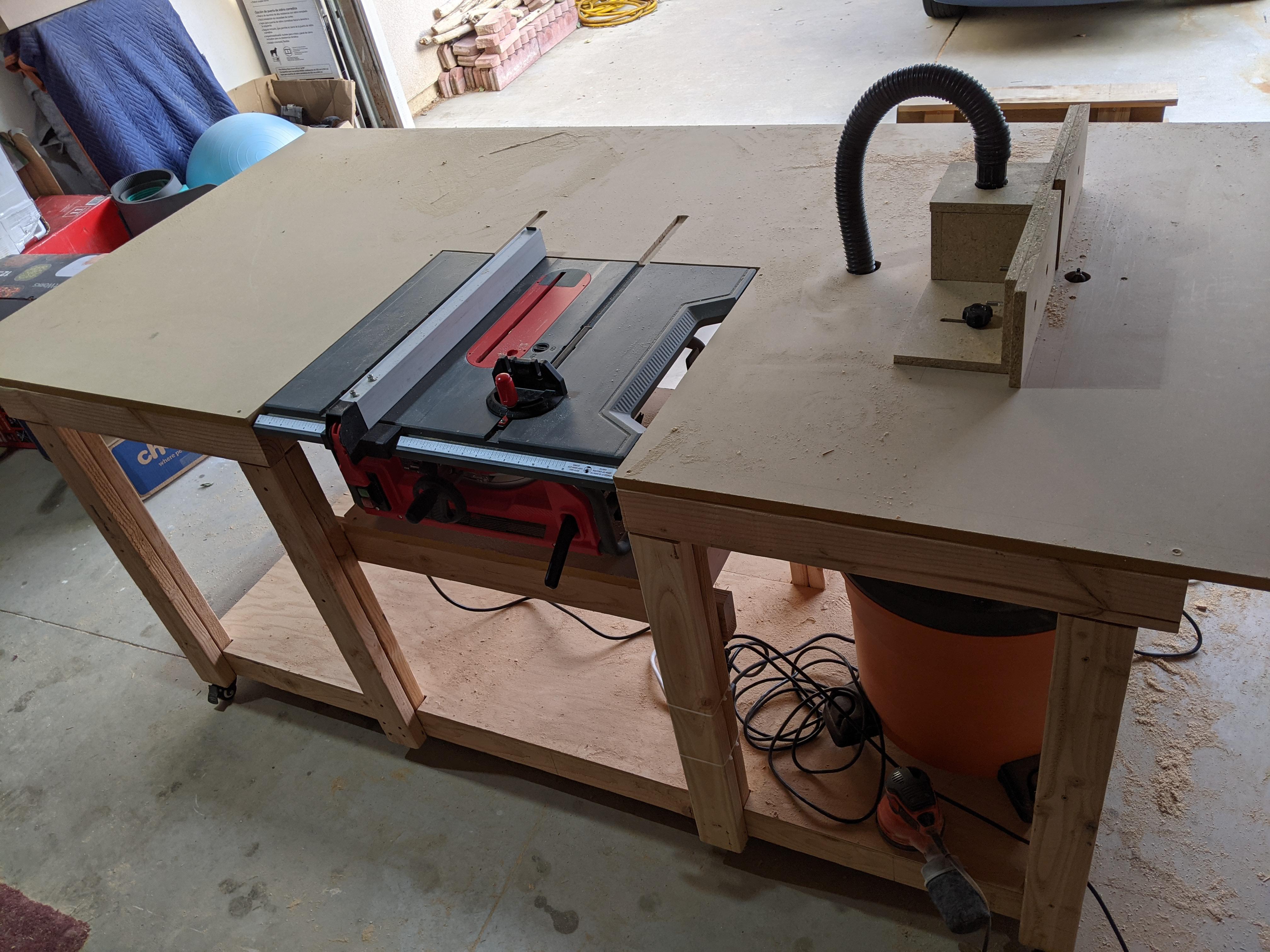 Finally finished my mobile workbench with a built in table saw and router inserts. | Scrolller