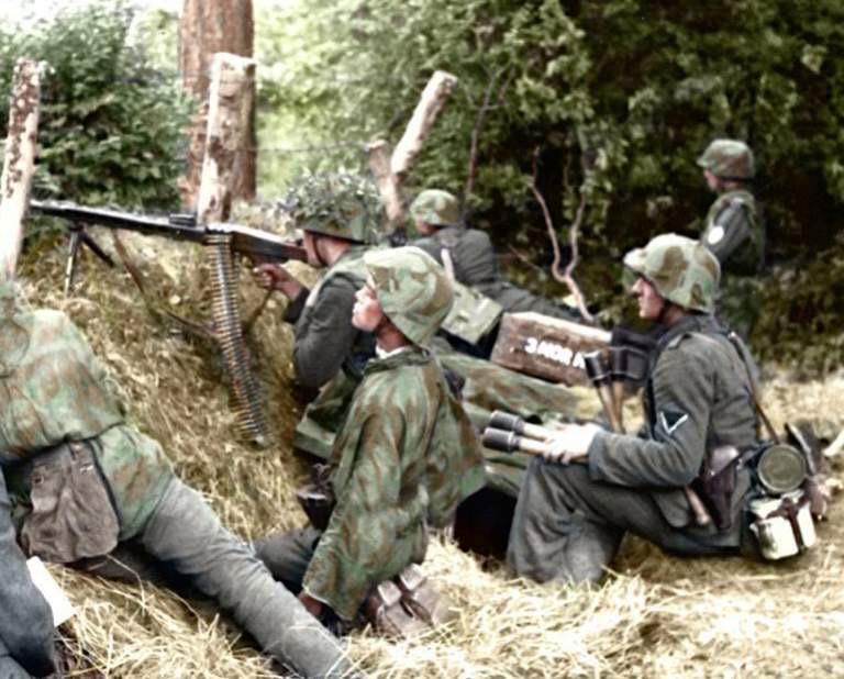 German machine gun crew posted behind hedgerow. | Scrolller