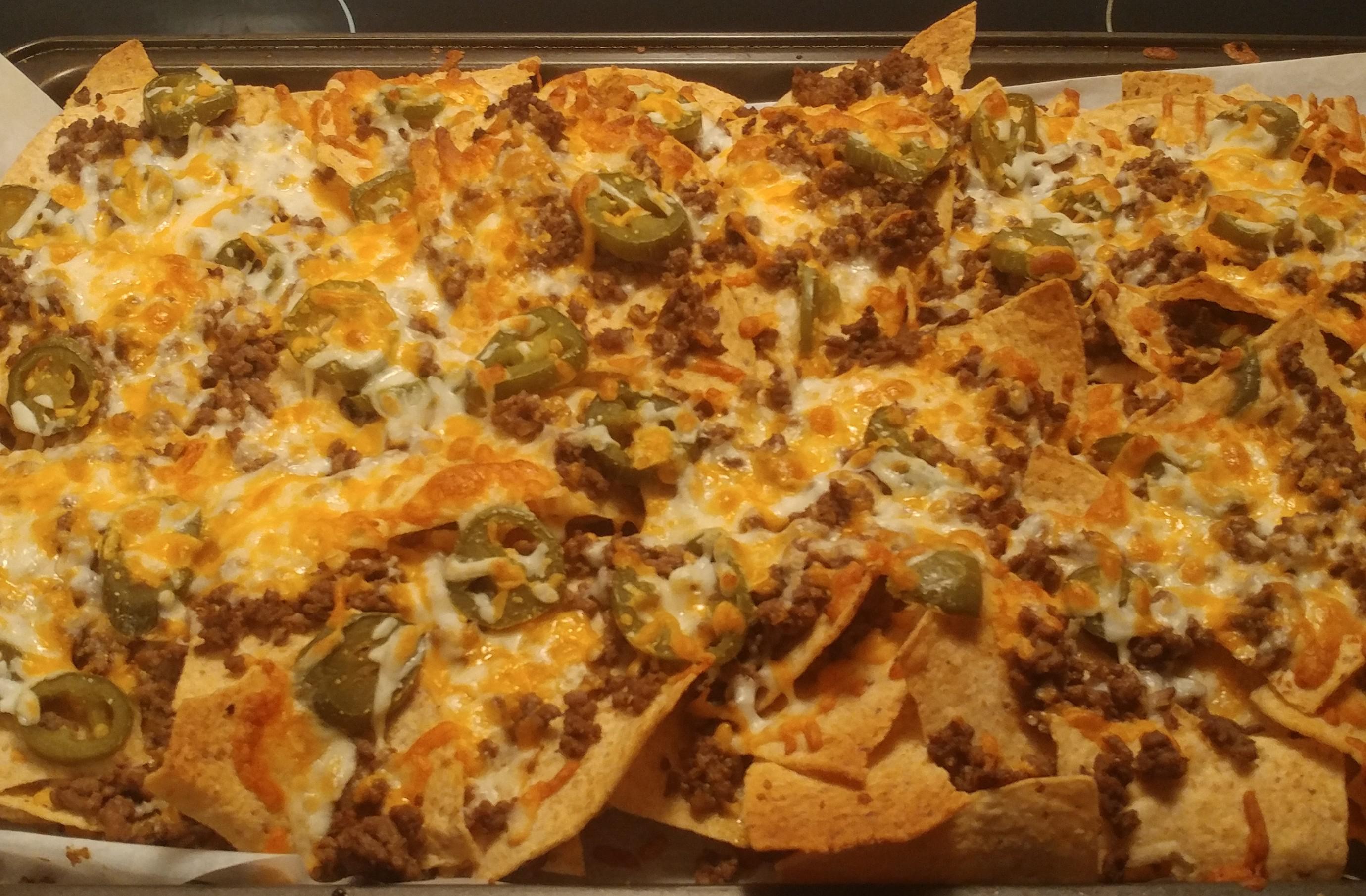 [Homemade] Double-layered beef nachos. Served with guac, salsa and refried beans with chilis ...