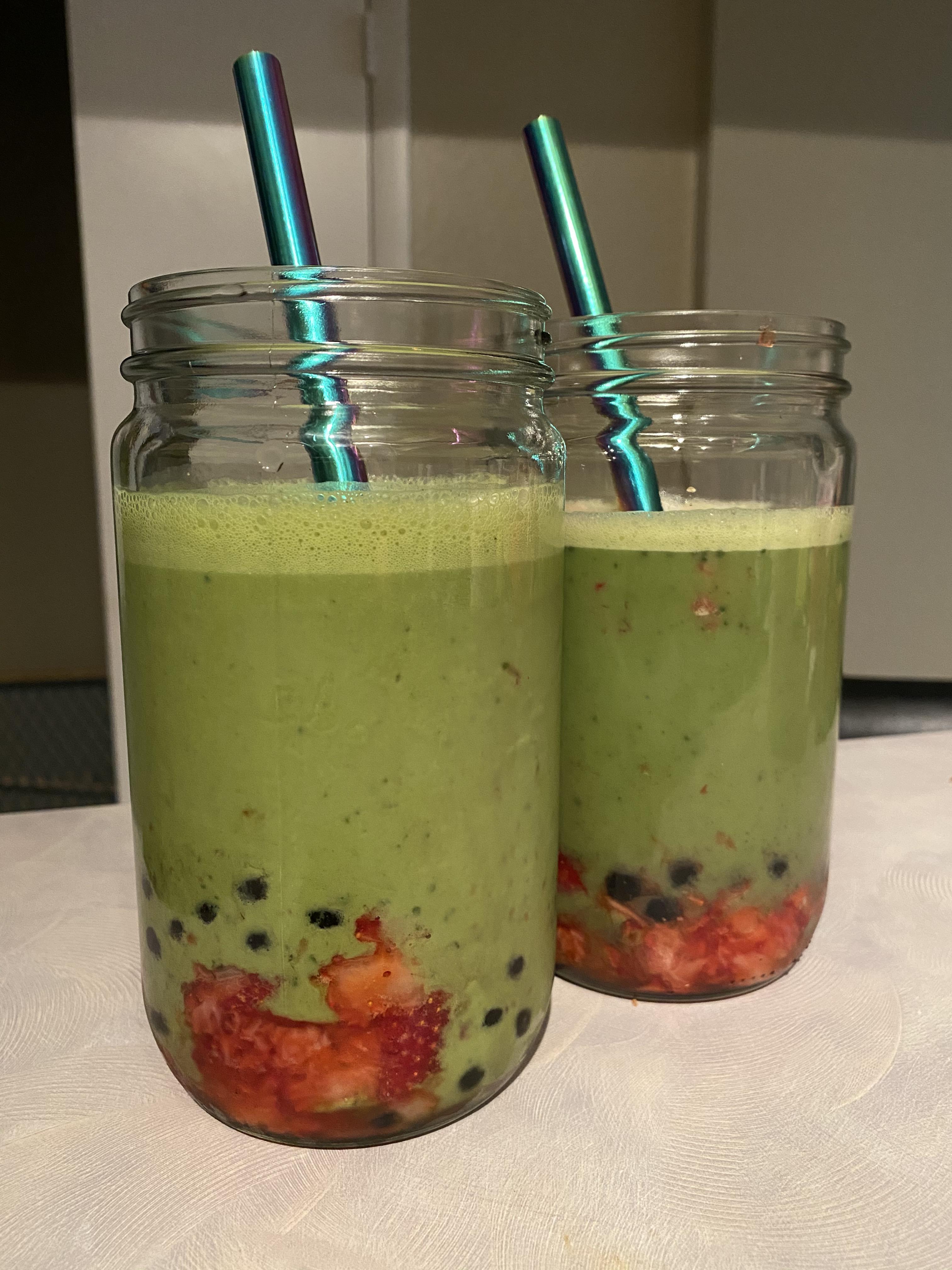 Homemade Oat Milk Iced Matcha with boba and strawberries!! I added a bit too much matcha powder ...