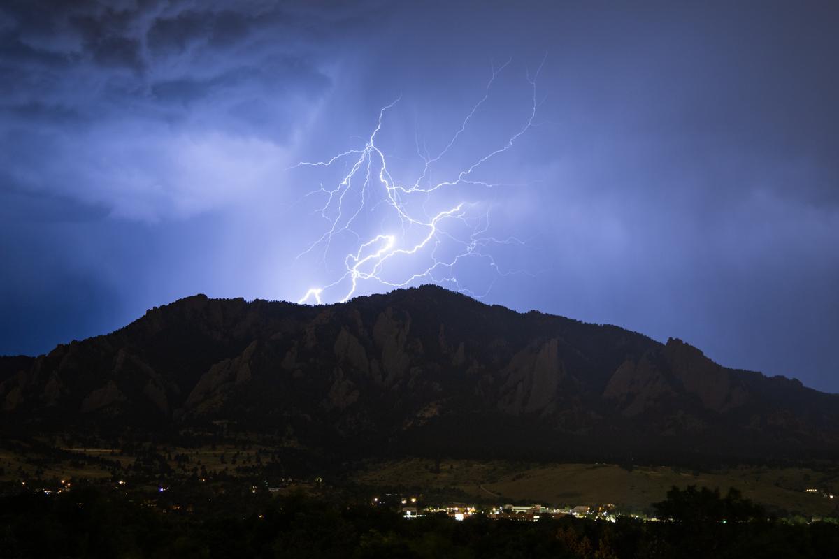 I caught a photo of a massive lightning strike illuminating the Flatirons during the storm last ...