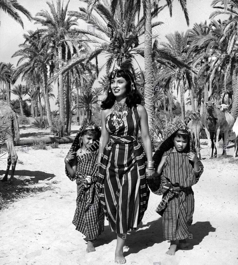 Italian actress and Libyan girls in "The Black Tent" - Waddan, Libya 1956 | Scrolller