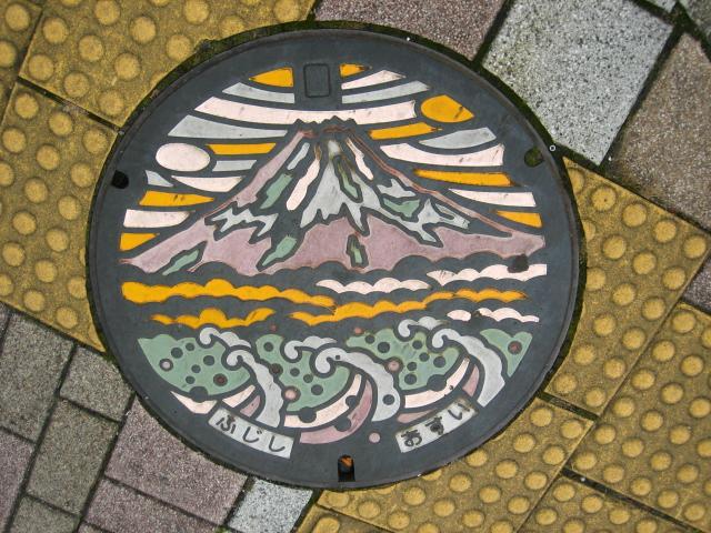 Manhole covers in Japan are often customized to the city. This is Fuji. | Scrolller