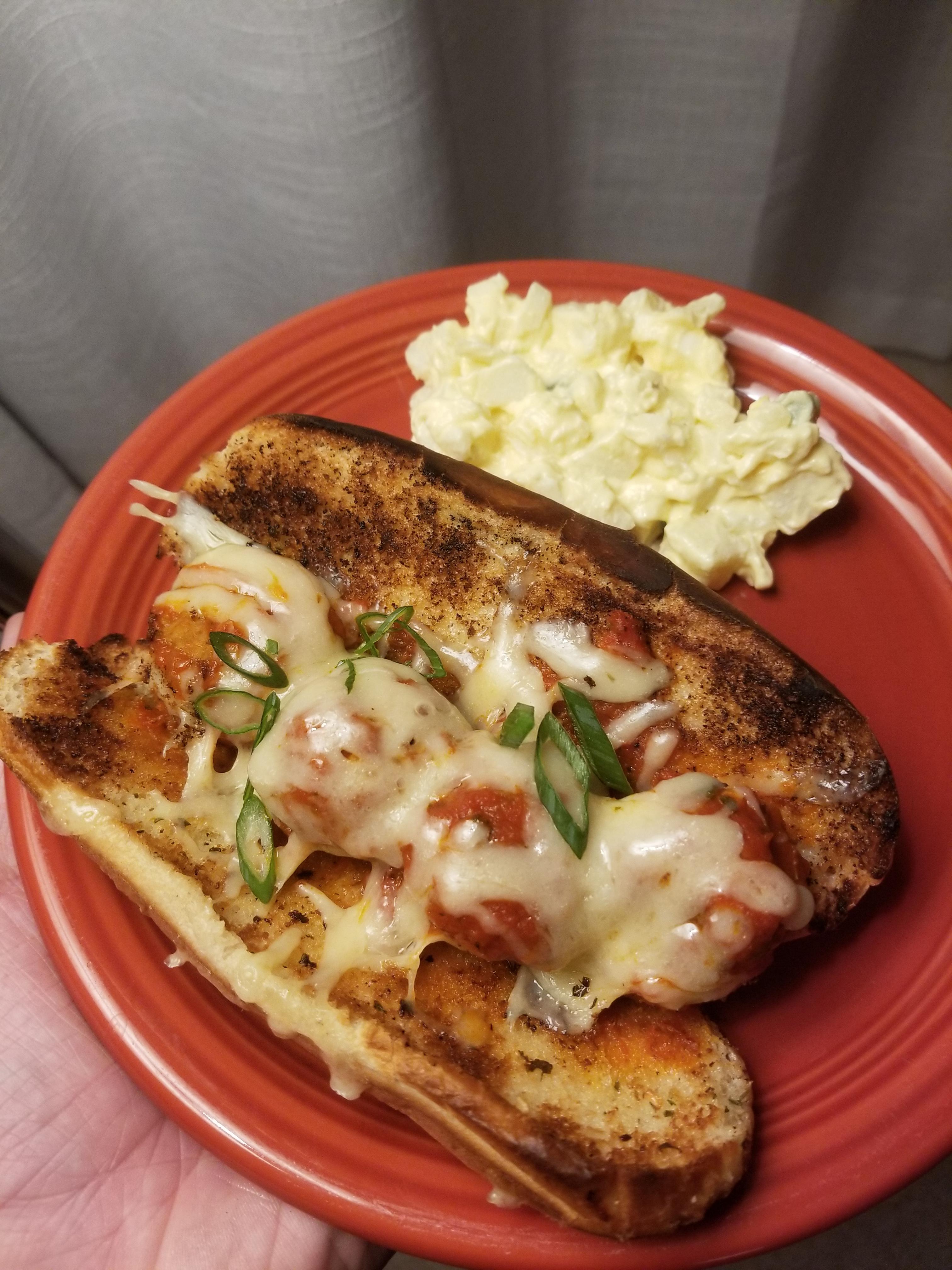 Meatball Sub with garlic butter, melted mozzarella, and green onions | Scrolller