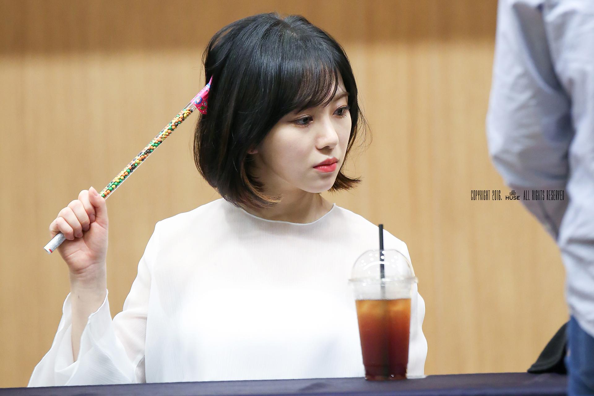 Mina scratching her head with a giant pencil | Scrolller