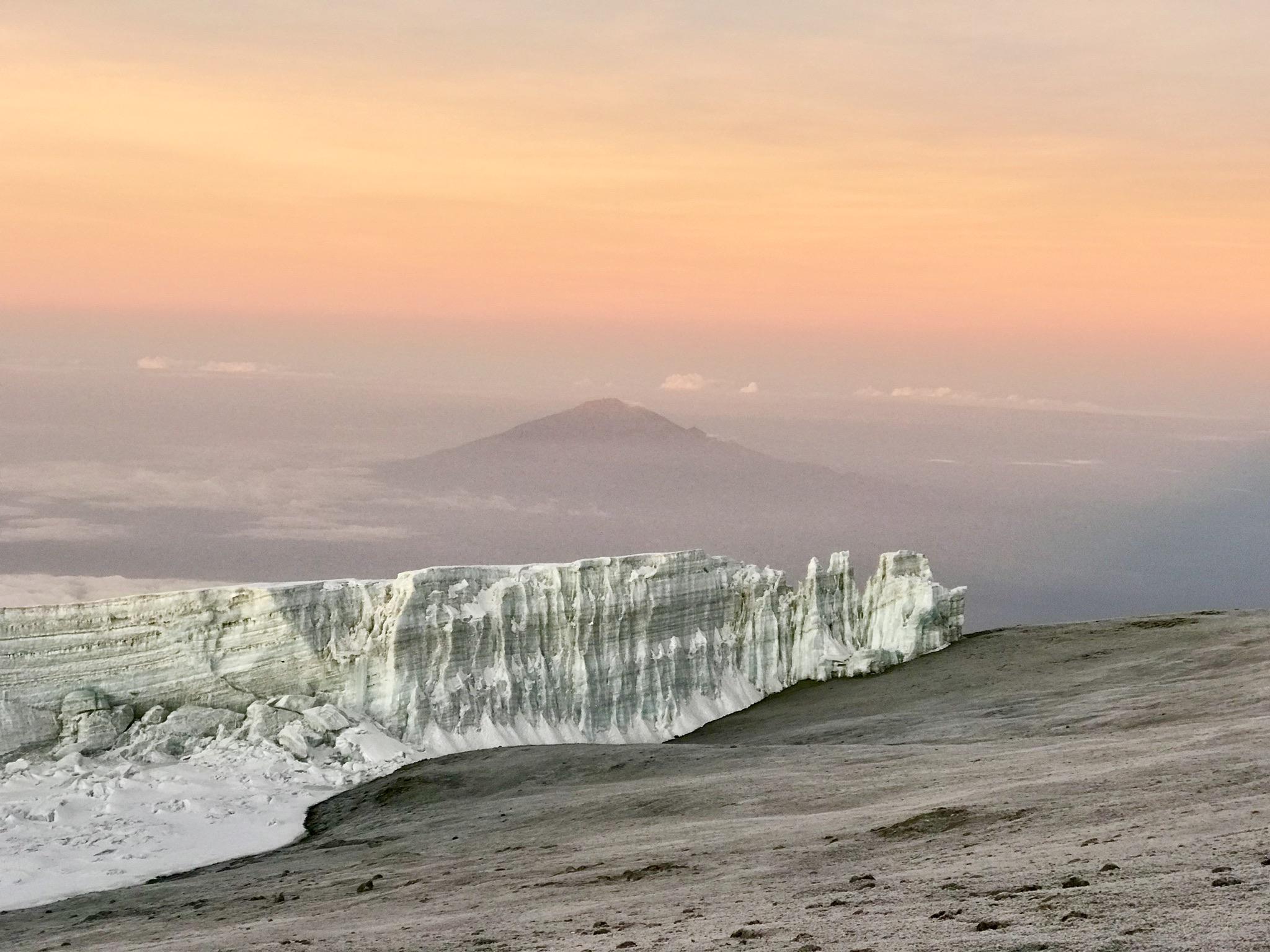Mount Meru over the southern icefield from Kilimanjaro summit at sunrise | Scrolller