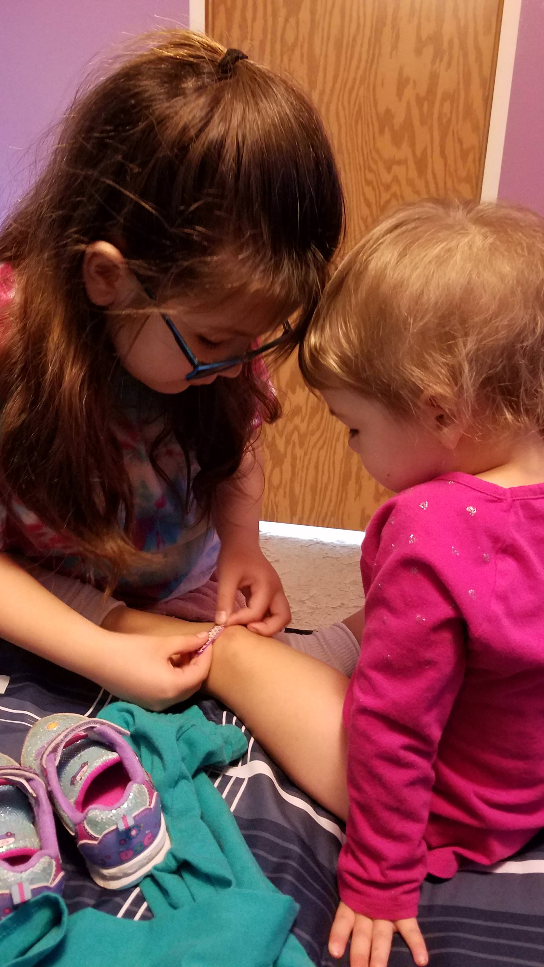 My 7yo fixing up my 2yo who skinned her knee | Scrolller