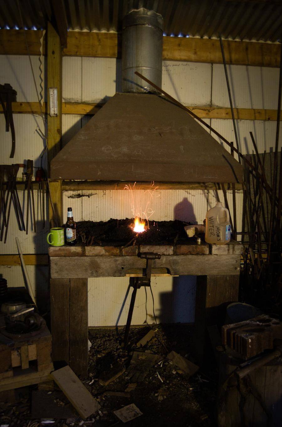 My big coal forge: electric blower, guillotine air gate, dirt floor over old oak barnwood ...
