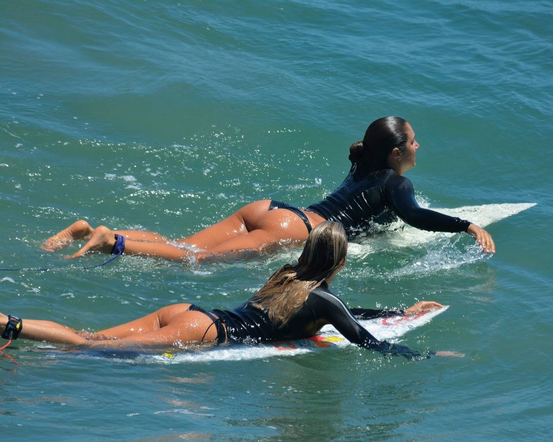 Paddling out to catch the waves. | Scrolller