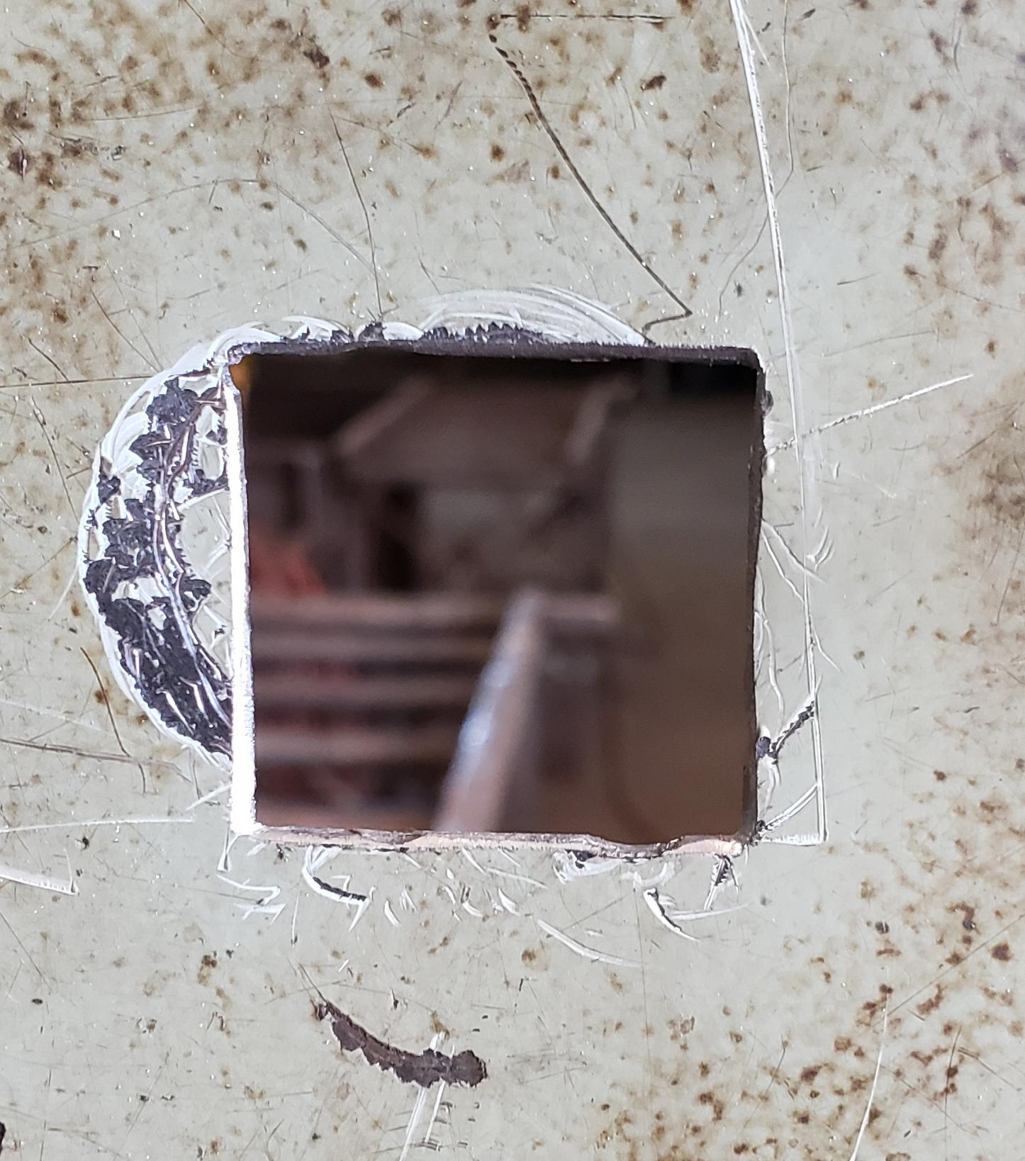 Square hole with filing. | Scrolller