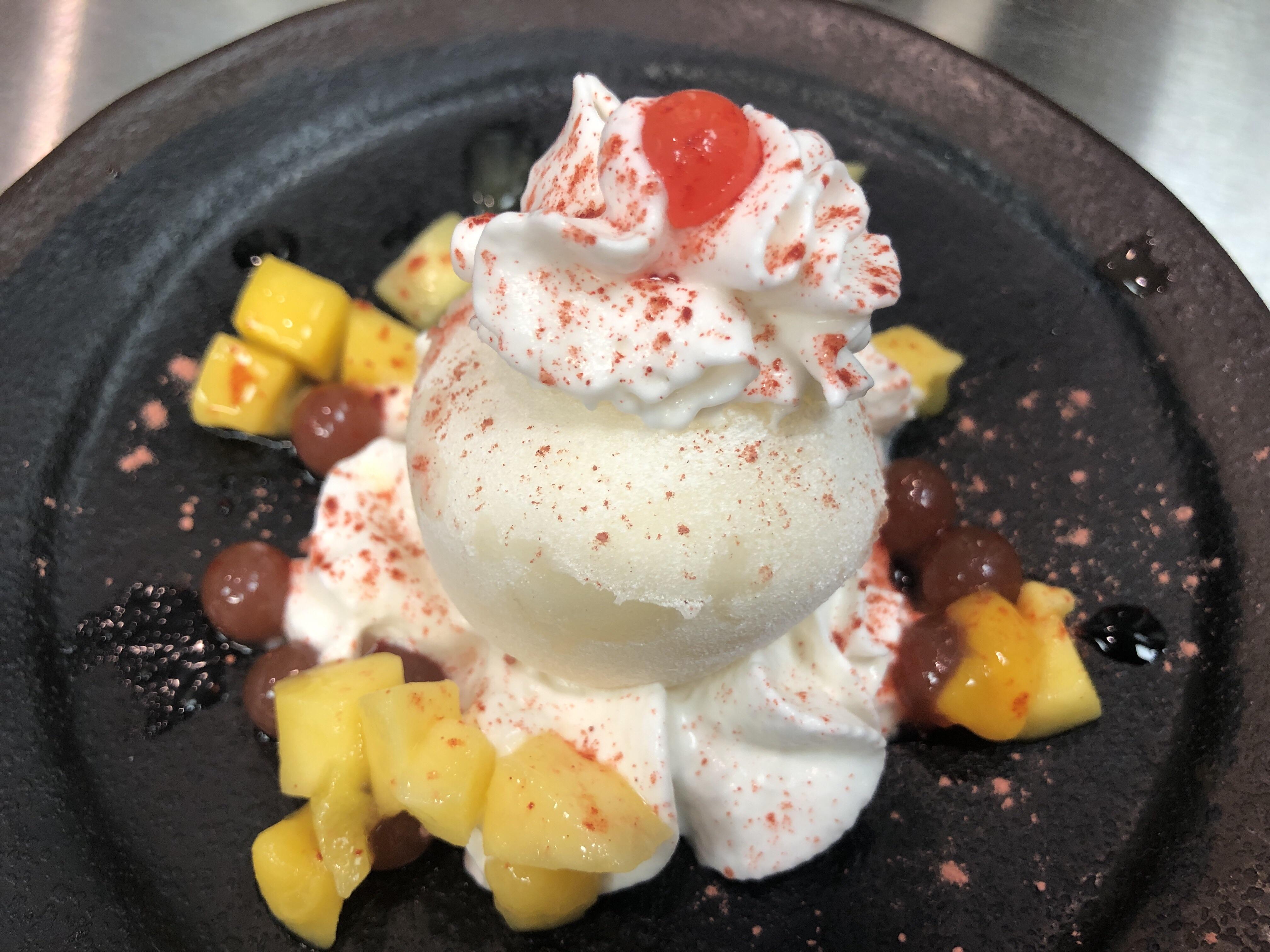 Strawberry popping boba, mango, vanilla mochi, whipped cream and li hing mui powder. | Scrolller