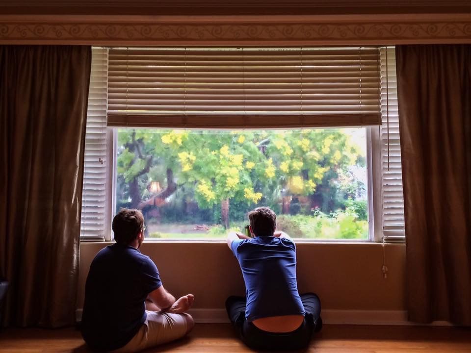 Two grown brothers watching the Hurricane outside | Scrolller