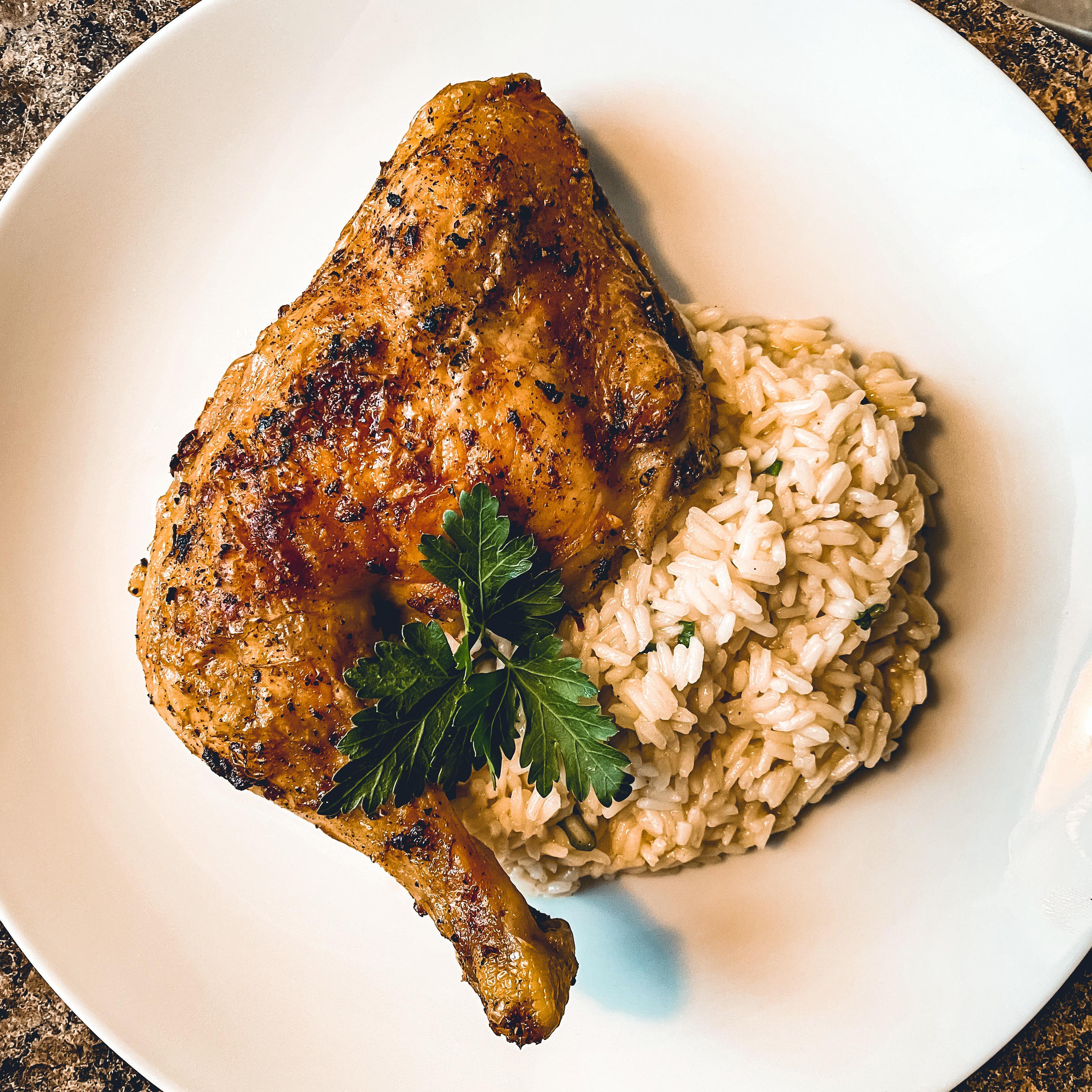 A simple oven roasted garlic chicken leg quarter with rice made from the pan drippings | Scrolller