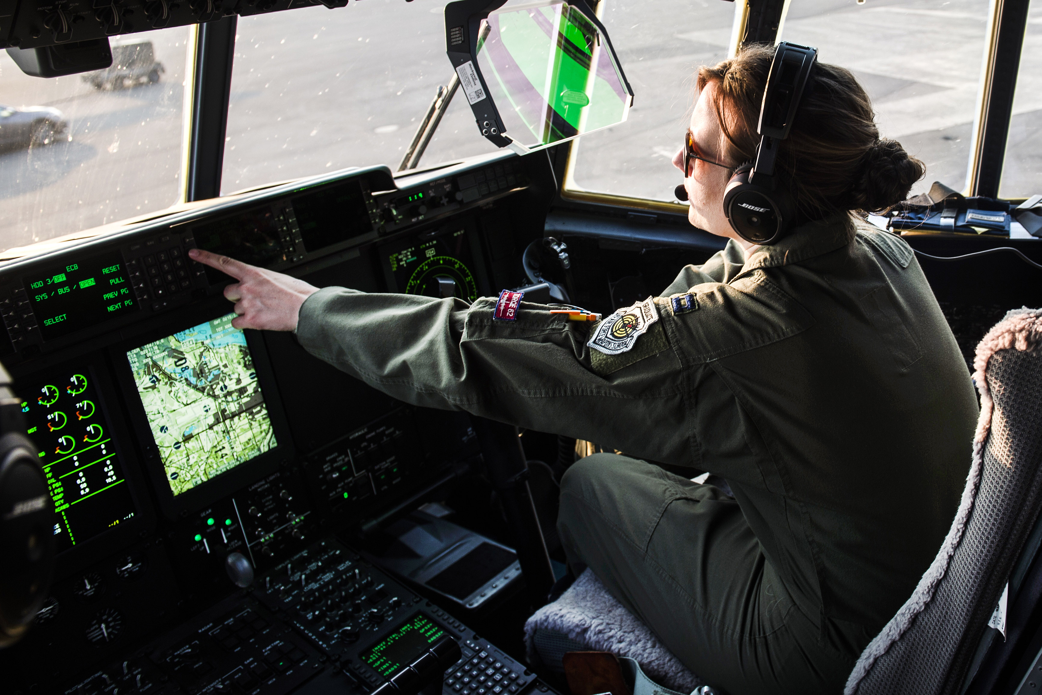 Air Force Capt. Caitlin Curran performs preflight checks aboard a C-130J Super Hercules during ...